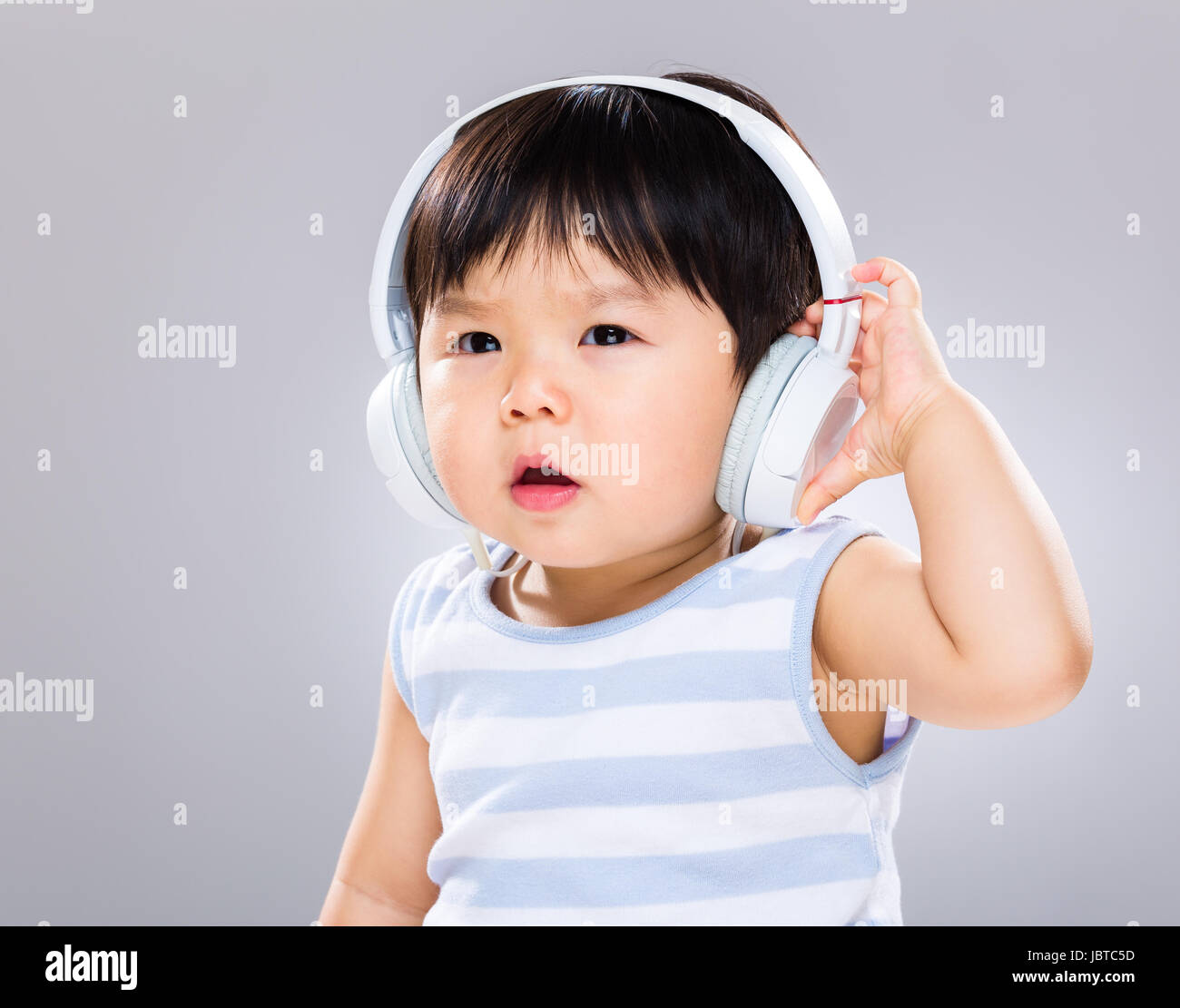Baby boy with headset Stock Photo - Alamy