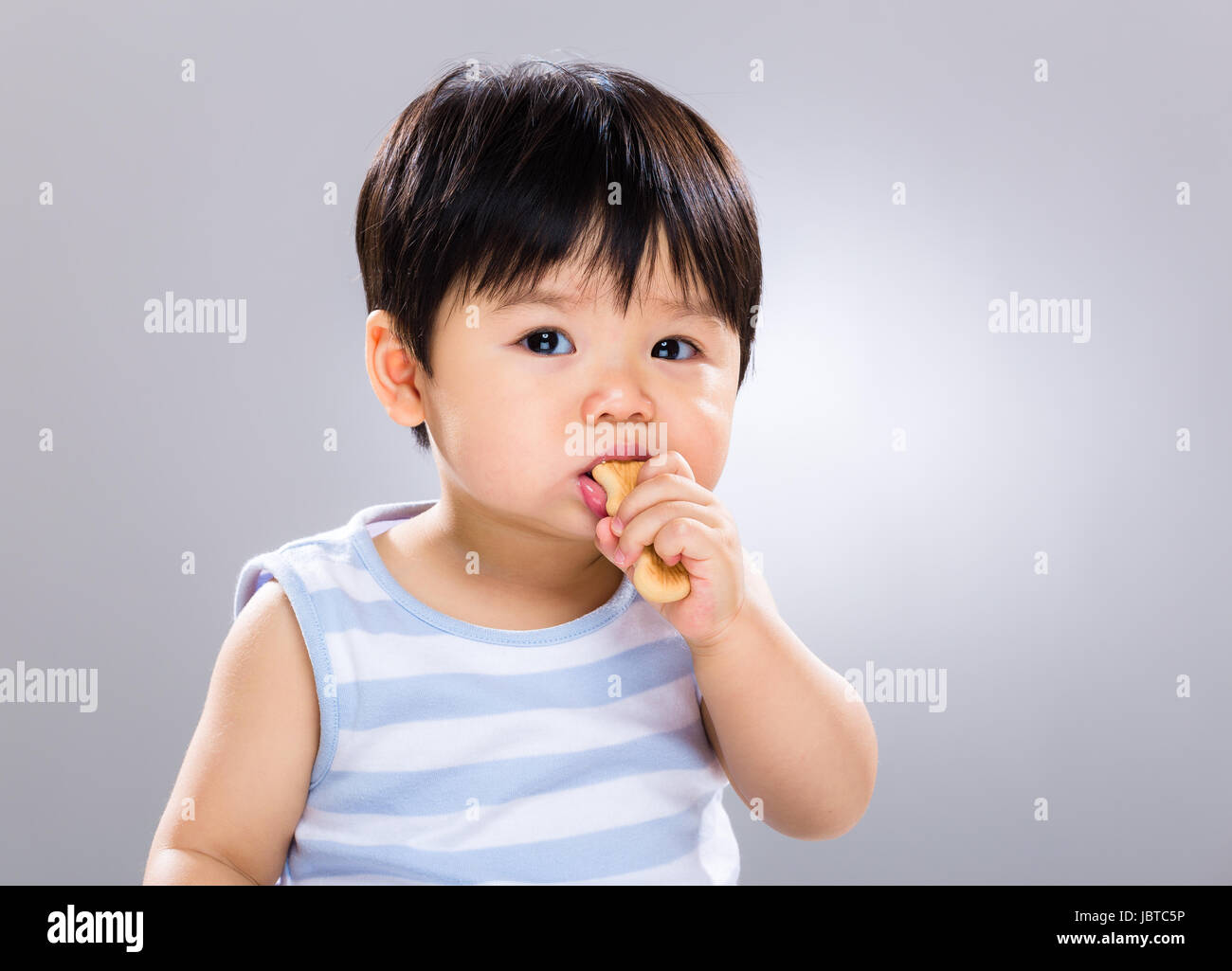 Little boy eat biscuit Stock Photo - Alamy