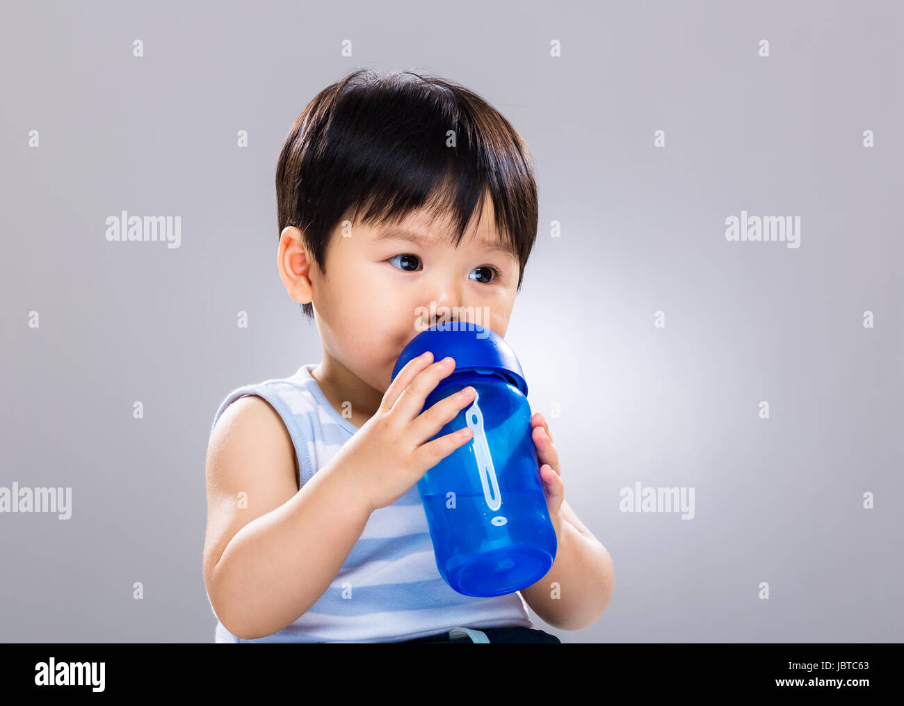 Baby boy drinking from bottle Stock Photo - Alamy