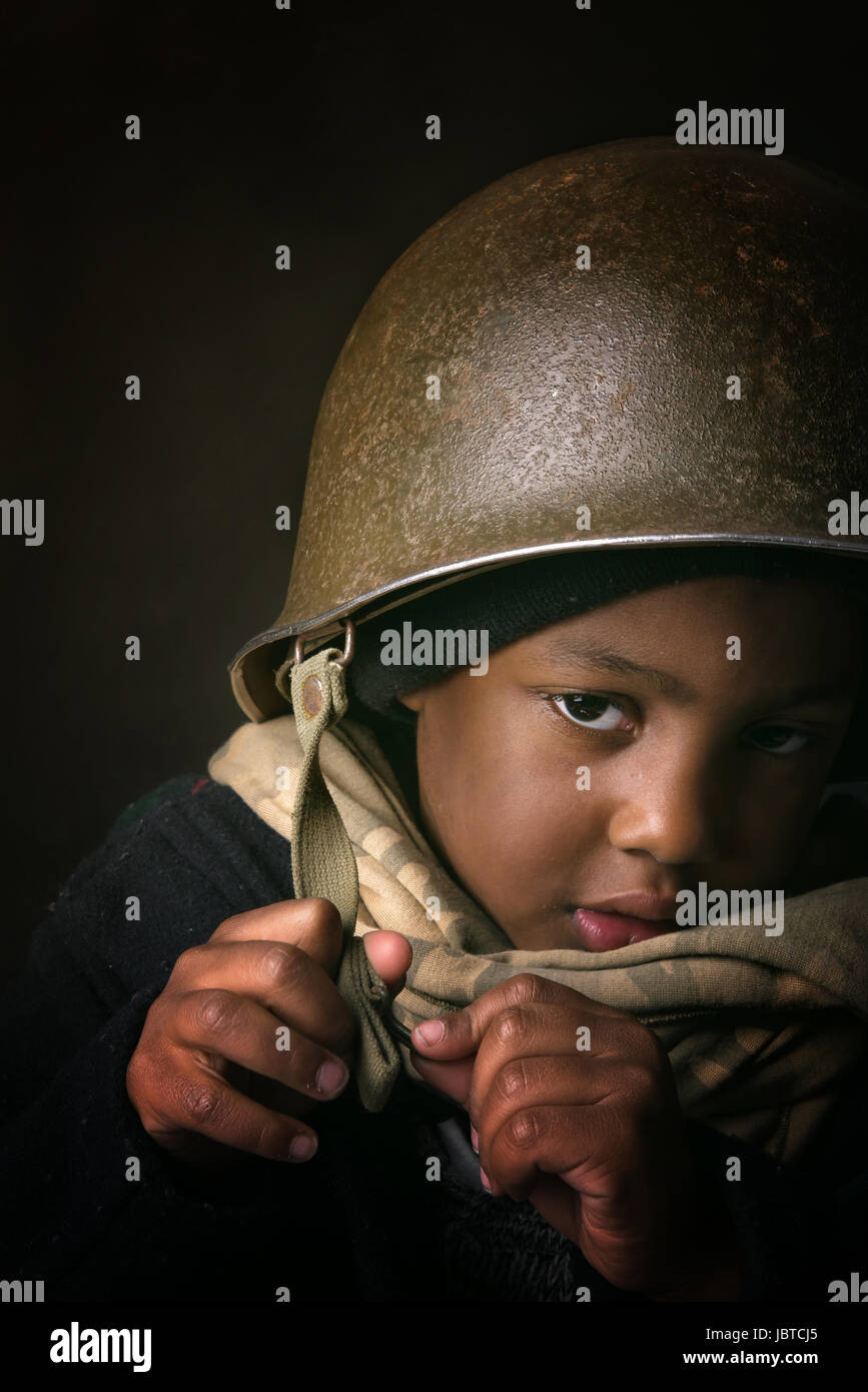 Young boy soldier portrait in a dark background Stock Photo - Alamy