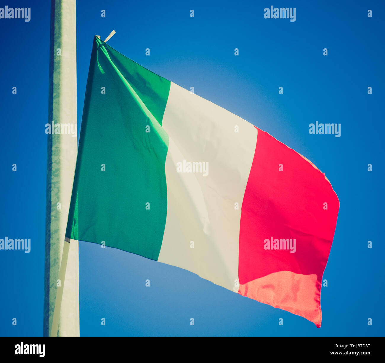 Vintage retro looking Flag of Italy over blue sky background Stock ...