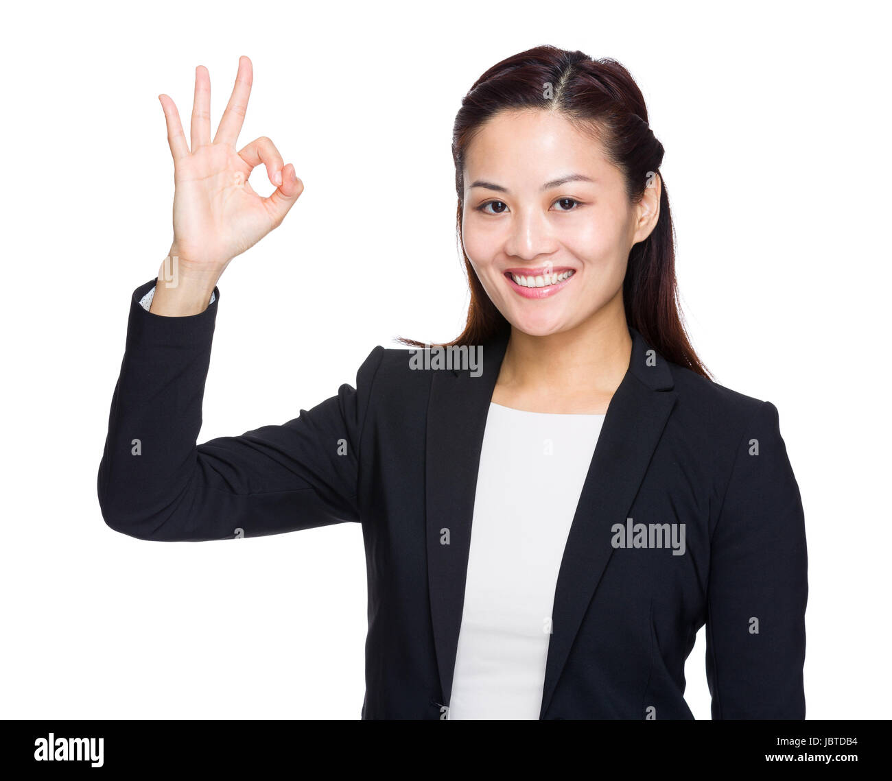 Business woman showing OK hand sign Stock Photo - Alamy