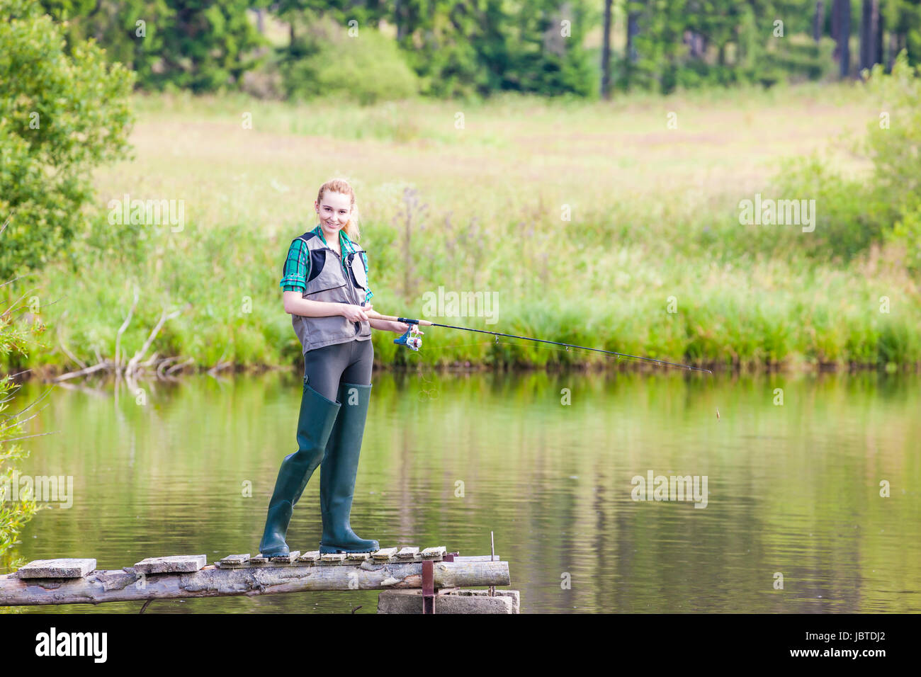 Standing young fisher woman hi-res stock photography and images - Alamy
