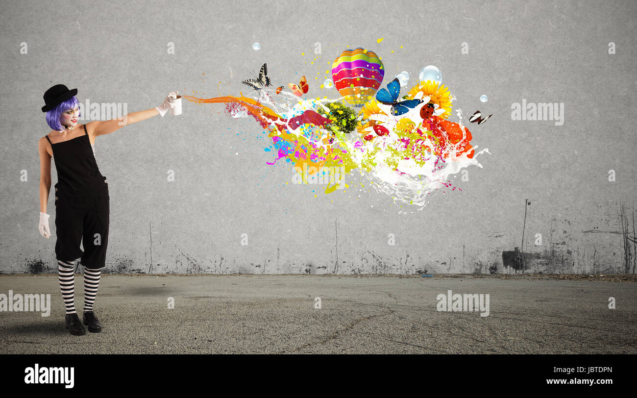 Woman clown with colored spray Stock Photo - Alamy
