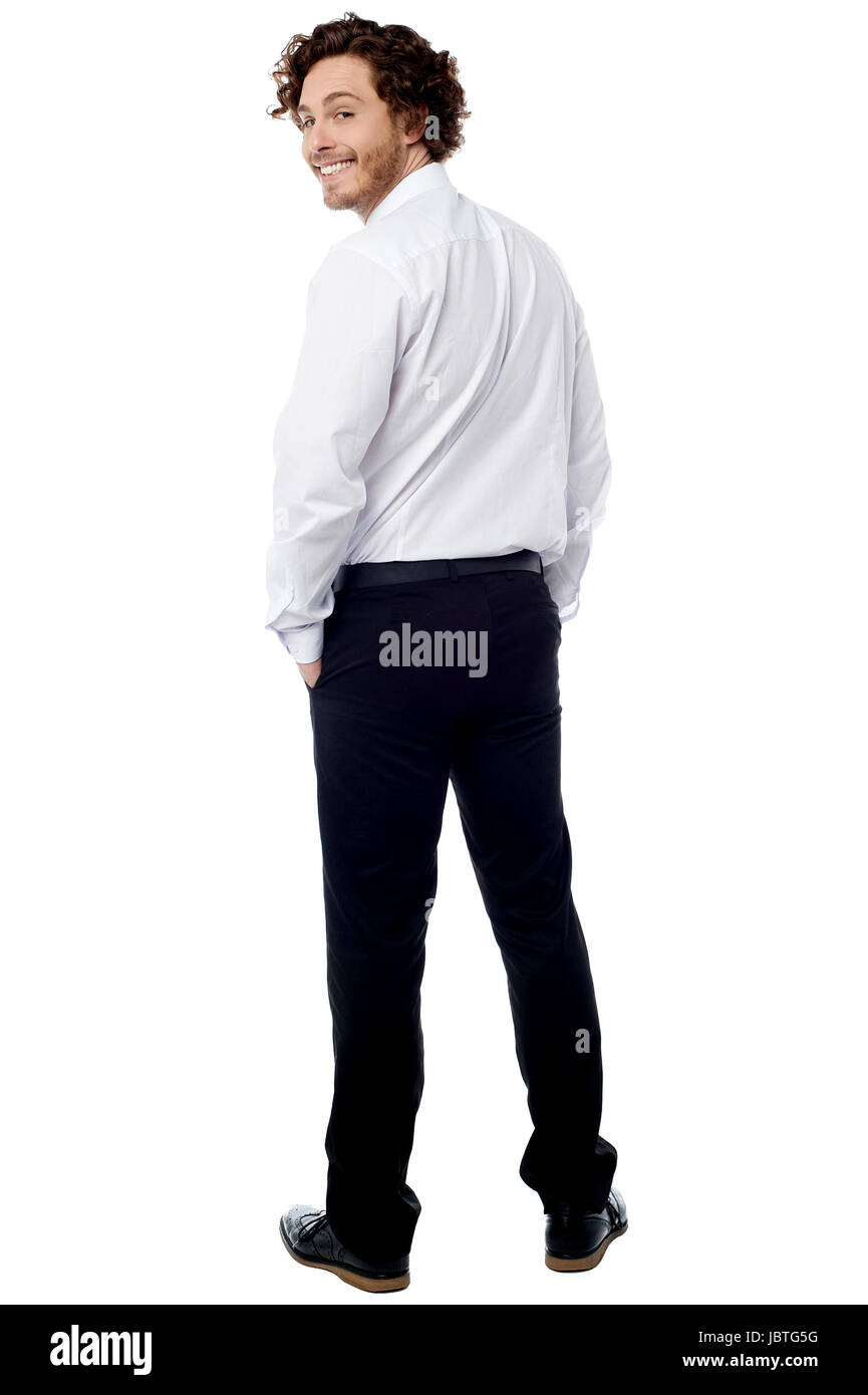 Smiling young guy turning back and looking at you Stock Photo - Alamy