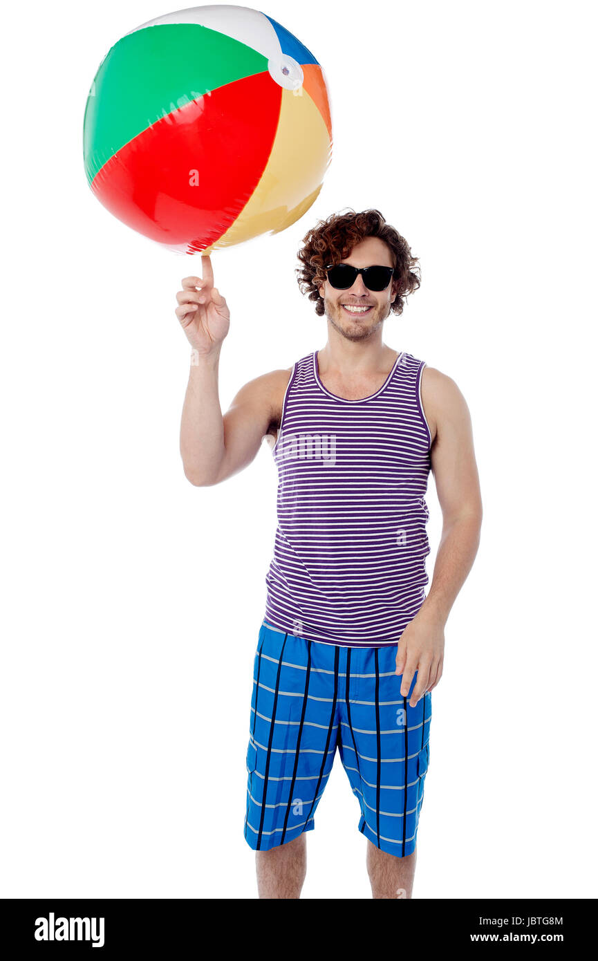 Young handsome guy playing with a beach ball Stock Photo - Alamy