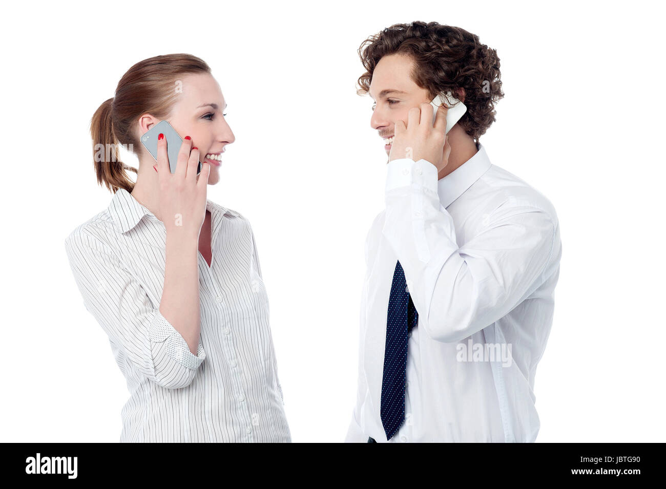 Young colleagues communicating over cell phone Stock Photo - Alamy