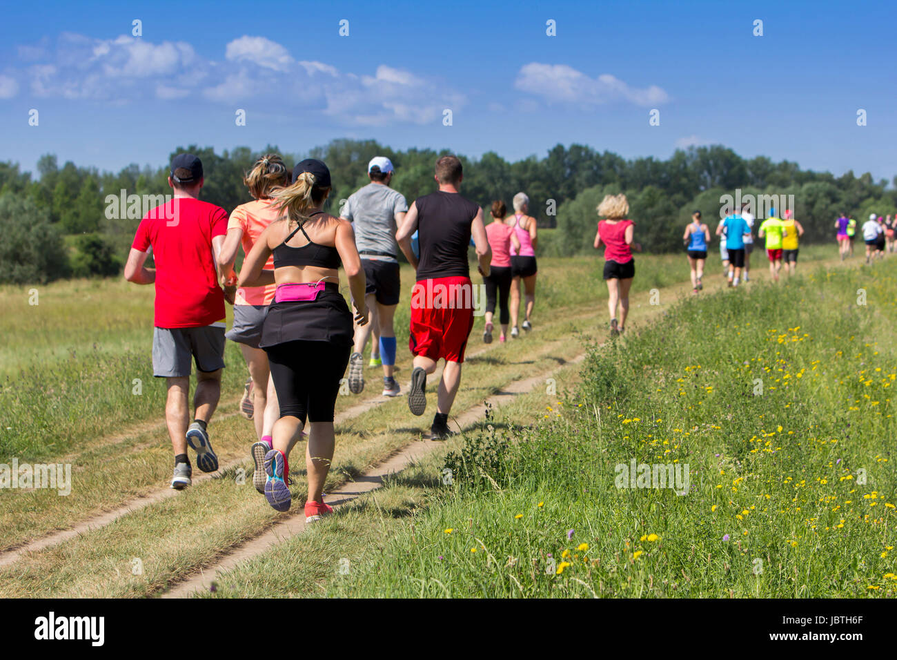 Outdoor cross-country running, Group of active people running in nature ...