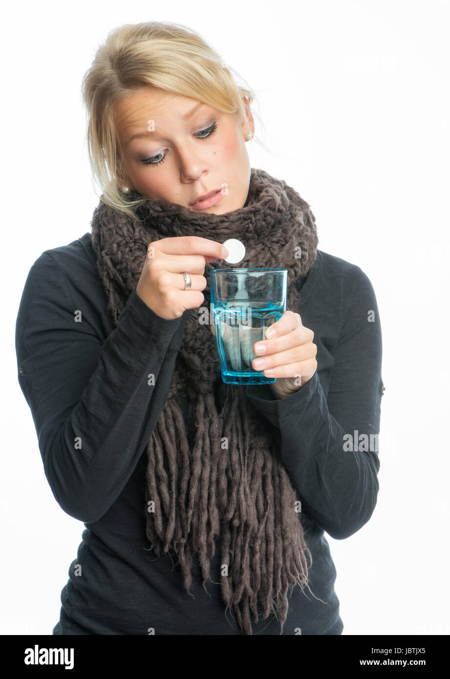sick blond woman effervescent tablet dissolves in water Stock Photo - Alamy