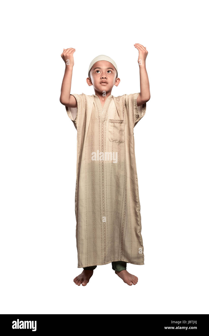 Portrait of asian muslim kid with cap praying isolated over white ...
