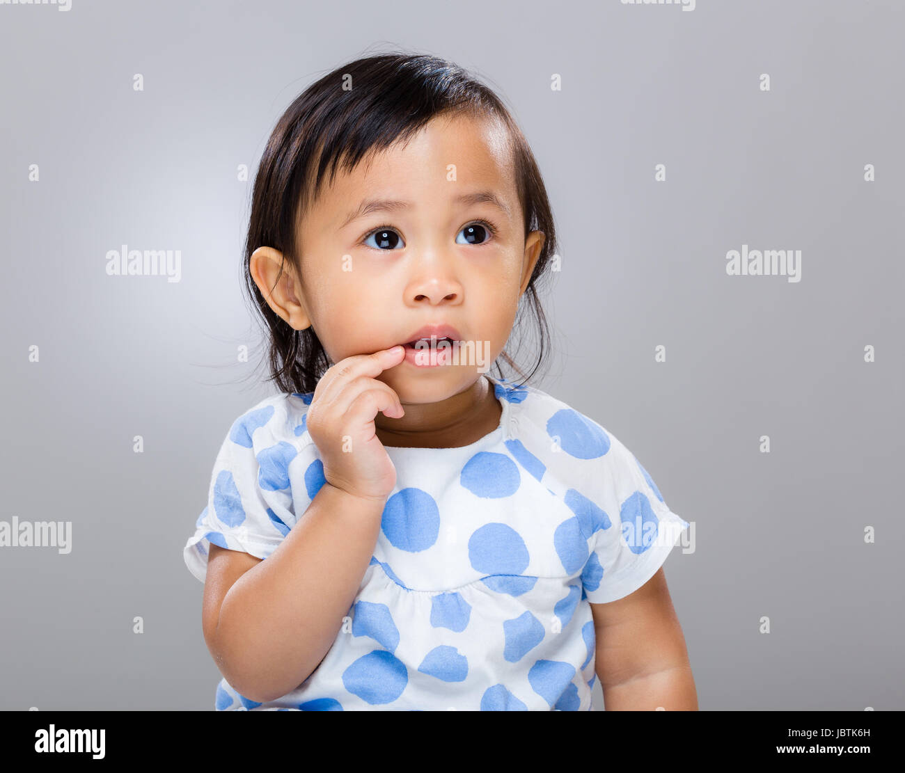 Baby girl finger touch mouth Stock Photo - Alamy
