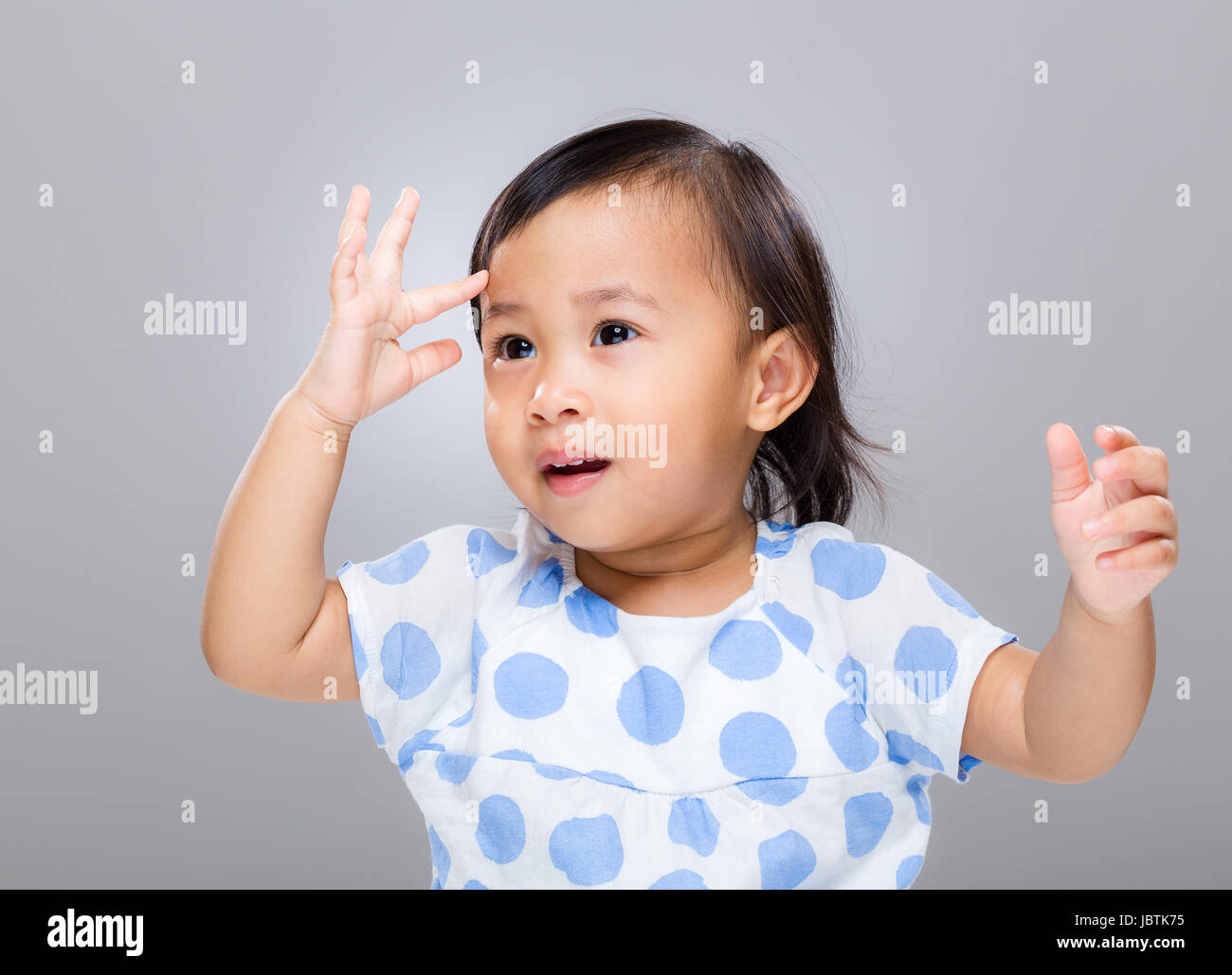 Little girl finger touch head Stock Photo - Alamy