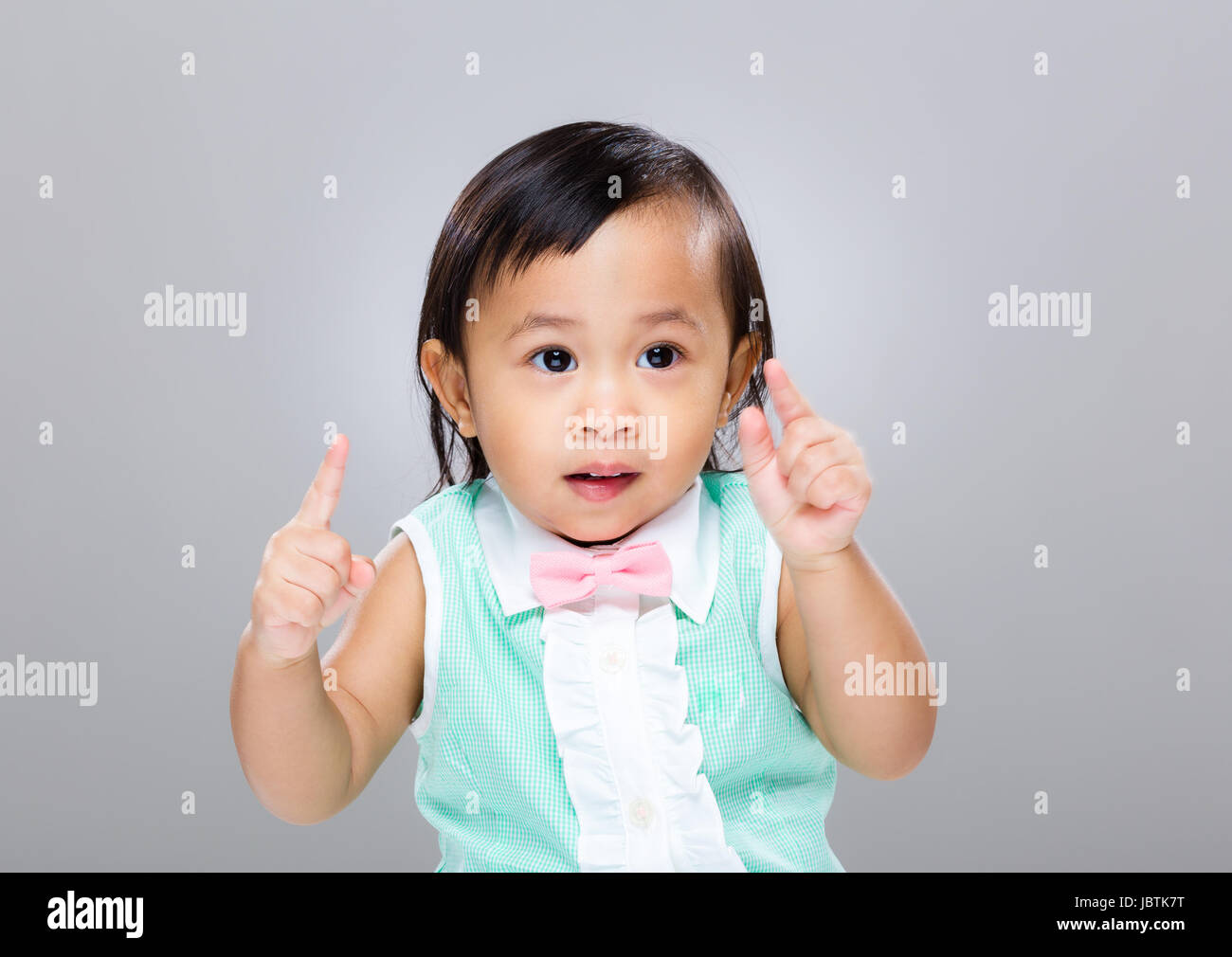 Cute baby girl finger raised up Stock Photo - Alamy