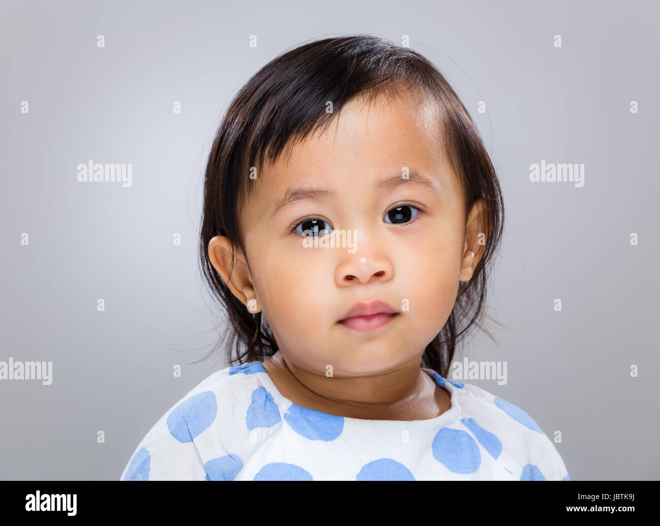Serious baby girl Stock Photo - Alamy