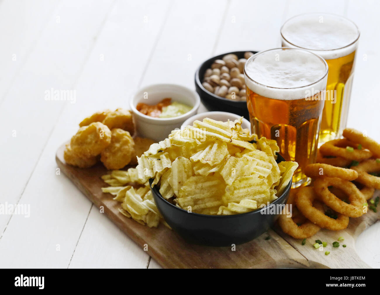 Alcohol and food. Beer with snacks on the table Stock Photo - Alamy