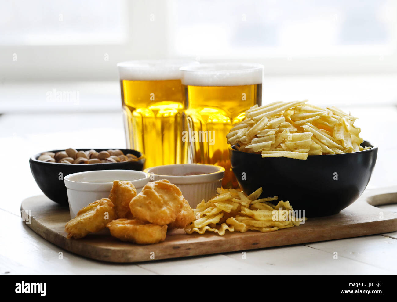 Alcohol and food. Beer with snacks on the table Stock Photo - Alamy