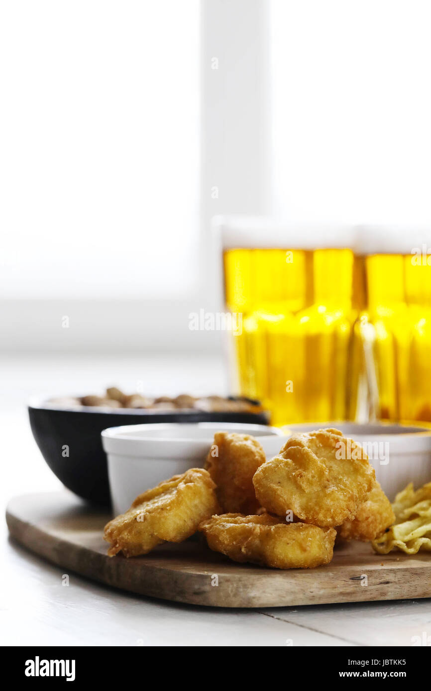 Alcohol and food. Beer with snacks on the table Stock Photo - Alamy