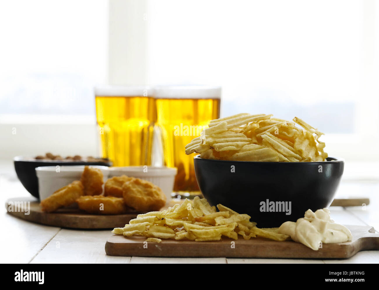 Alcohol and food. Beer with snacks on the table Stock Photo - Alamy
