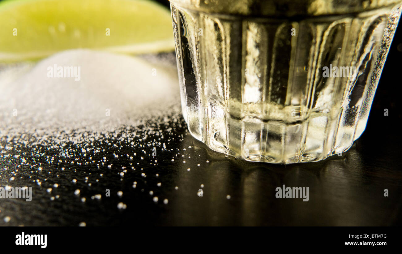 The bottom of a misted glass of tequila salt and lime closeup Stock ...