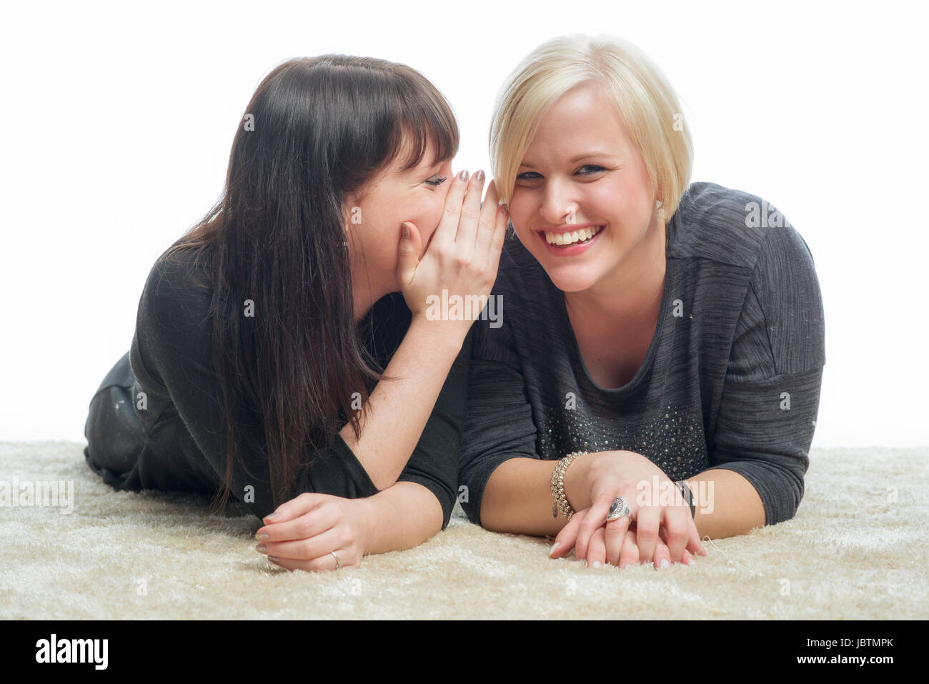 whisper 2 girlfriends Stock Photo - Alamy