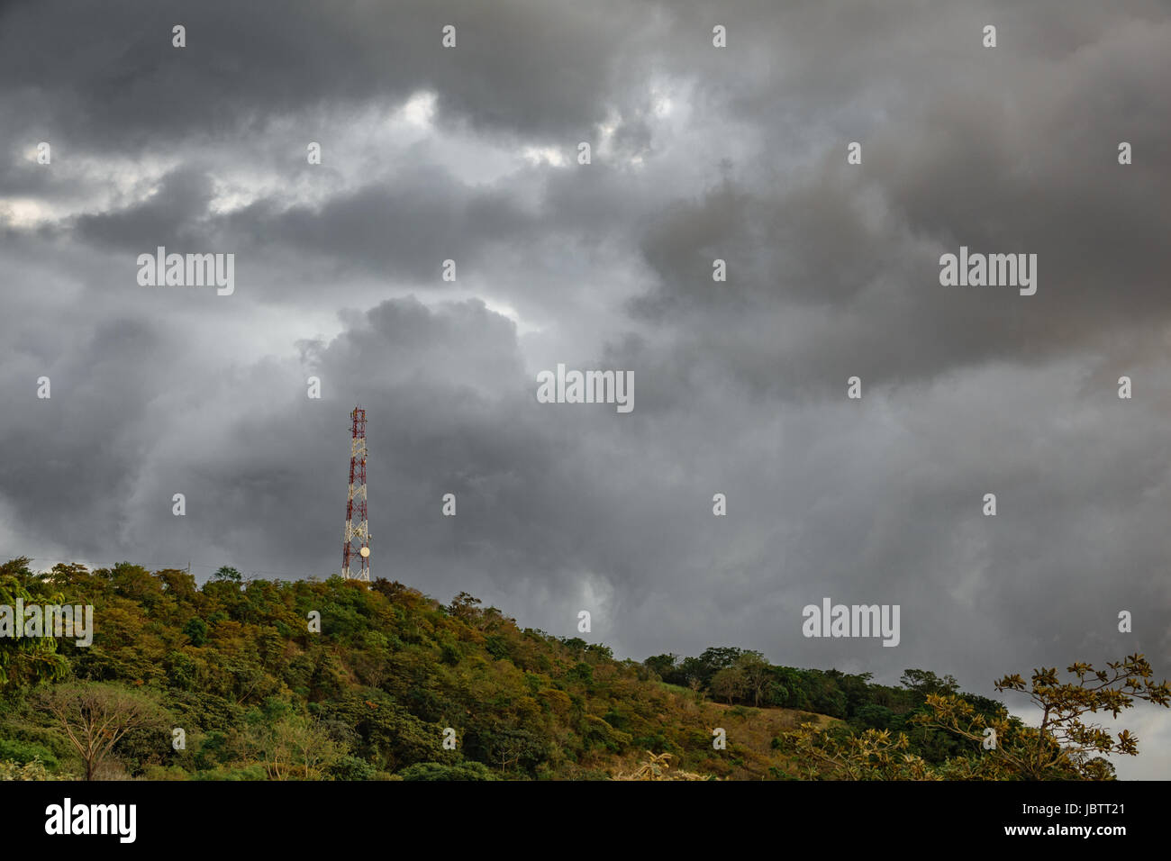 Long shot of communication tower at top of mountain with cloudy sky, storm Stock Photo - Alamy