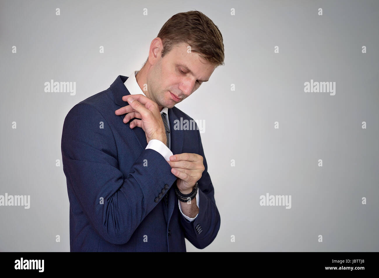 Man in the suit fixing his cufflinks Stock Photo - Alamy