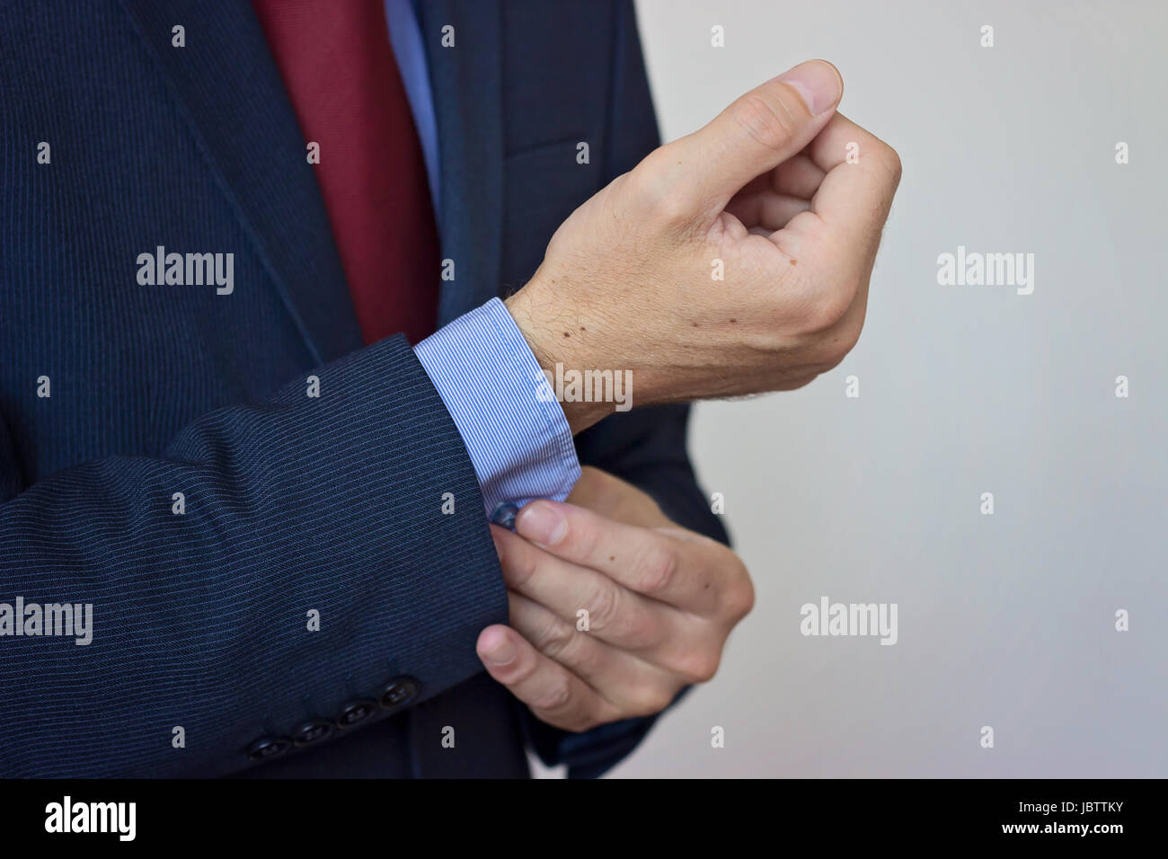 Man in the suit fixing his cufflinks Stock Photo - Alamy