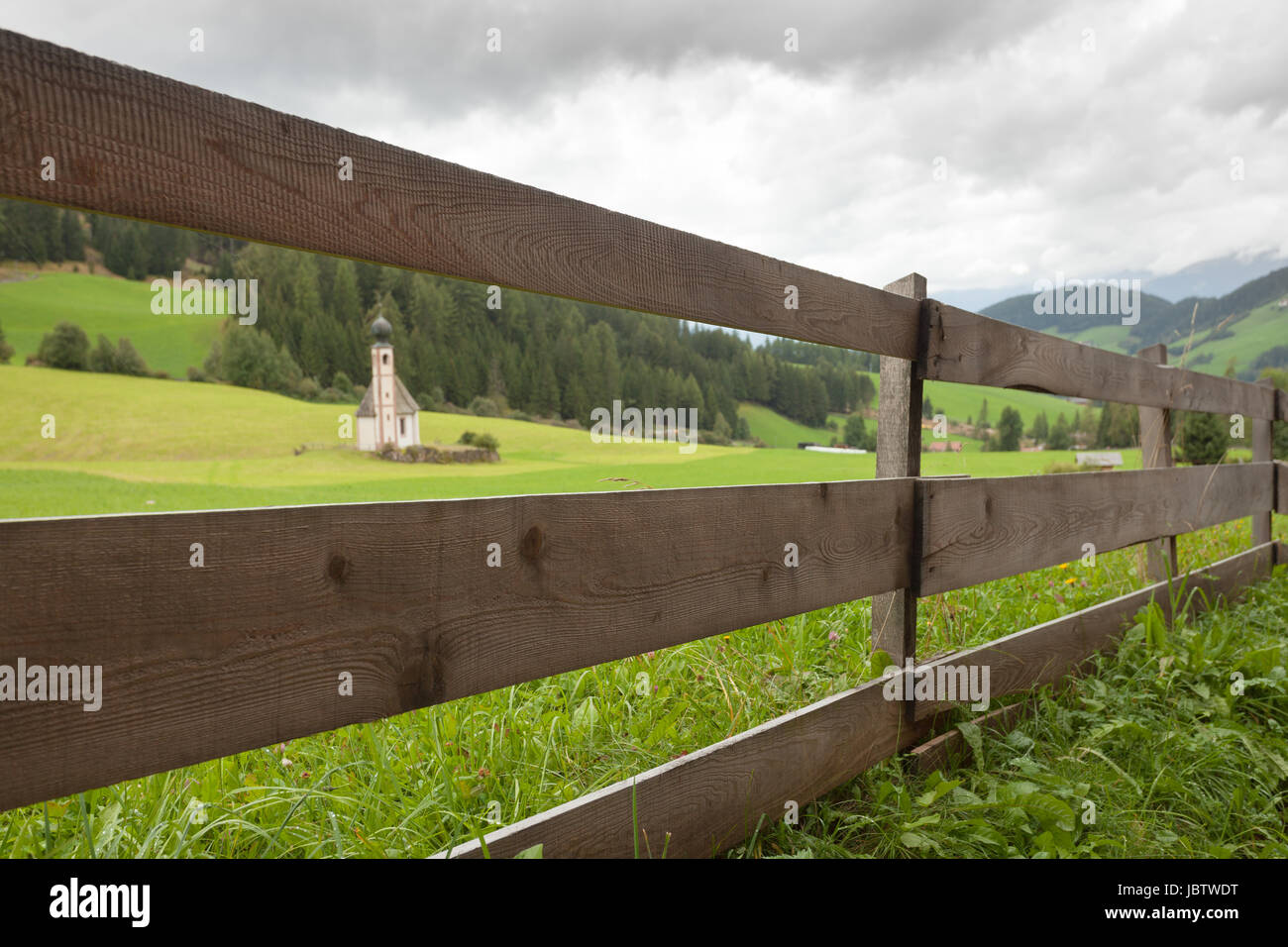 Wooden fence next to an Italian mountain pasture Stock Photo - Alamy