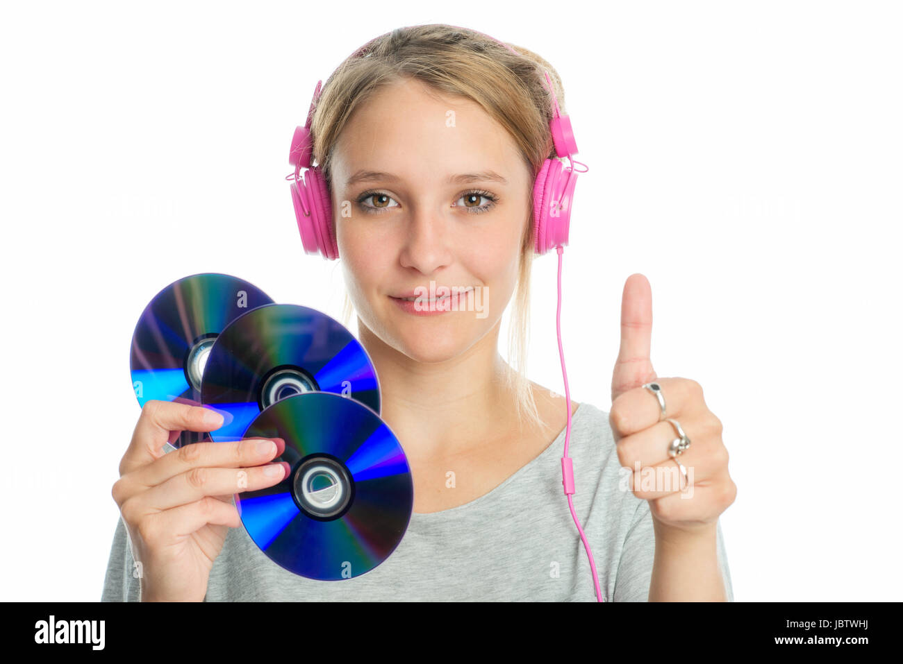 blond girl with headphones holding a few cd blanks Stock Photo - Alamy