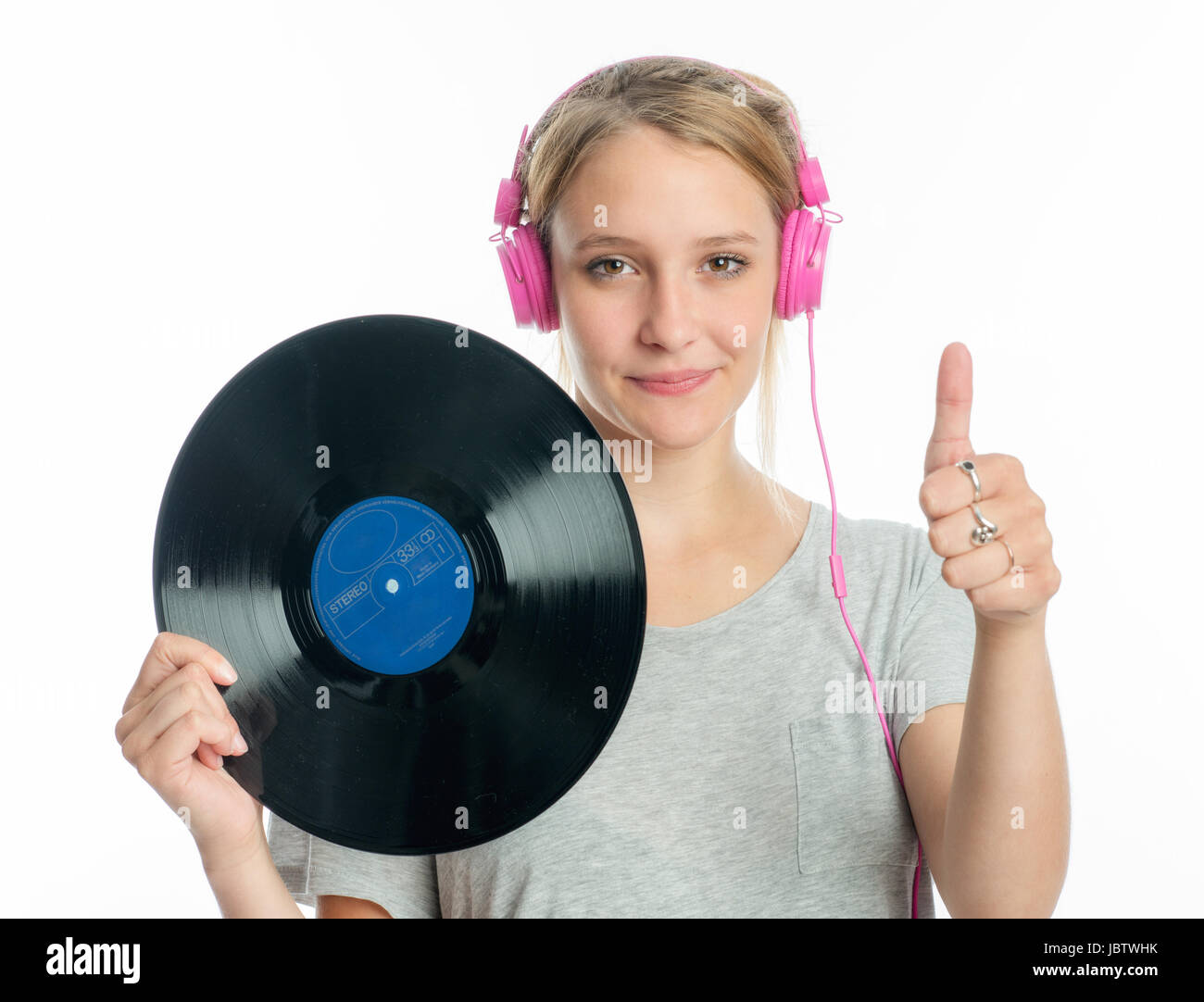 blond girl with headphones holding a record Stock Photo - Alamy
