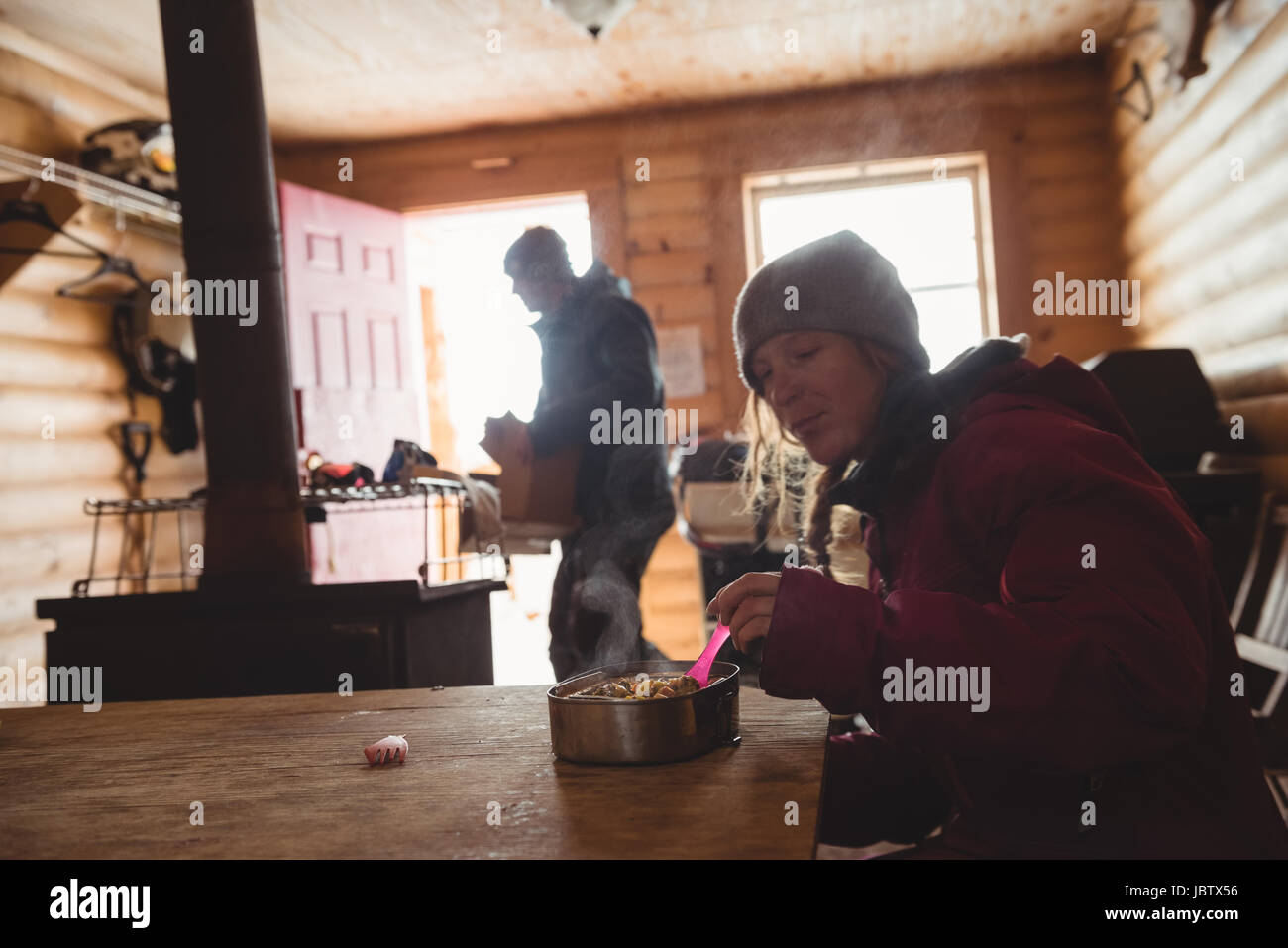 Woman sitting in log cabin hi-res stock photography and images - Alamy