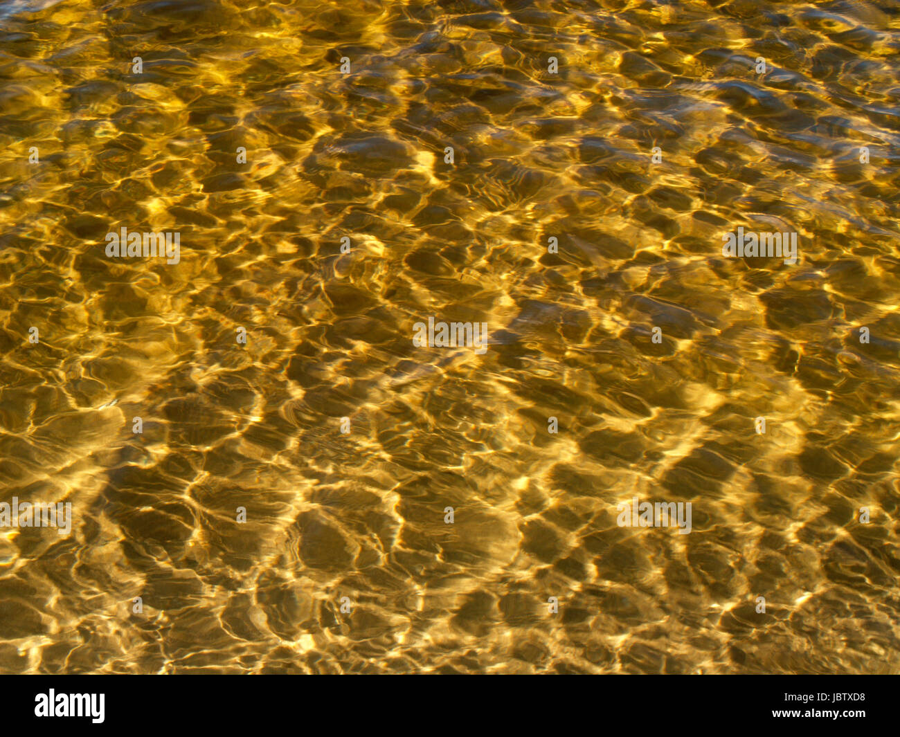 Sunlight on water Stock Photo - Alamy
