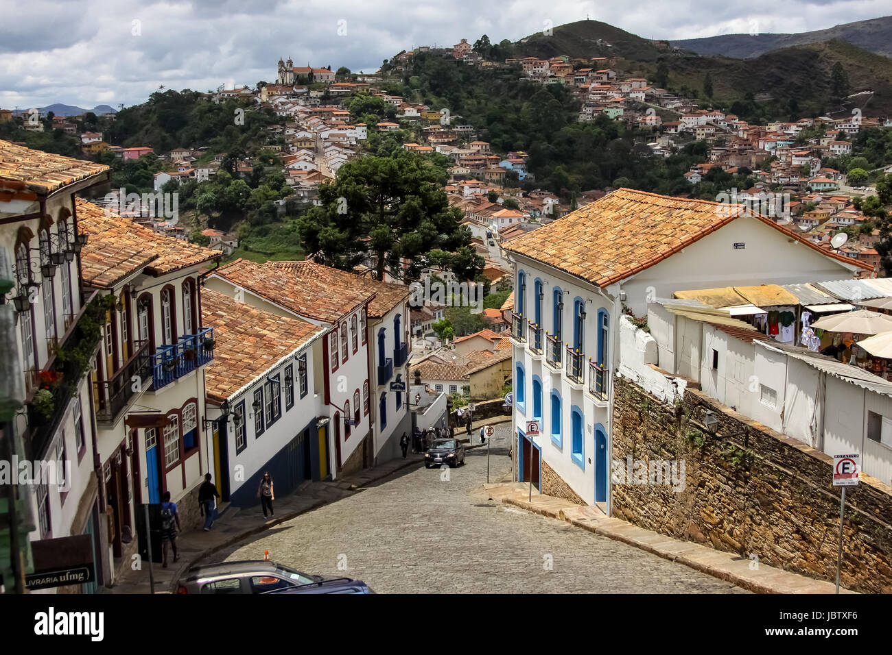 View of steep cobblestone street and hills of historic baroque city ...