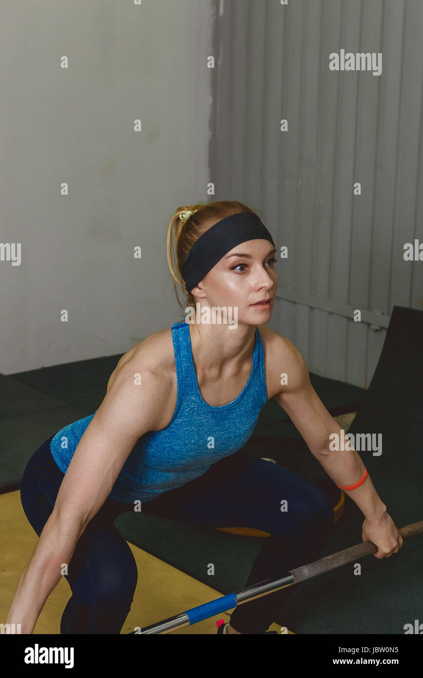Strong Woman Lifting Barbell As A Part Of Crossfit Exercise Routine