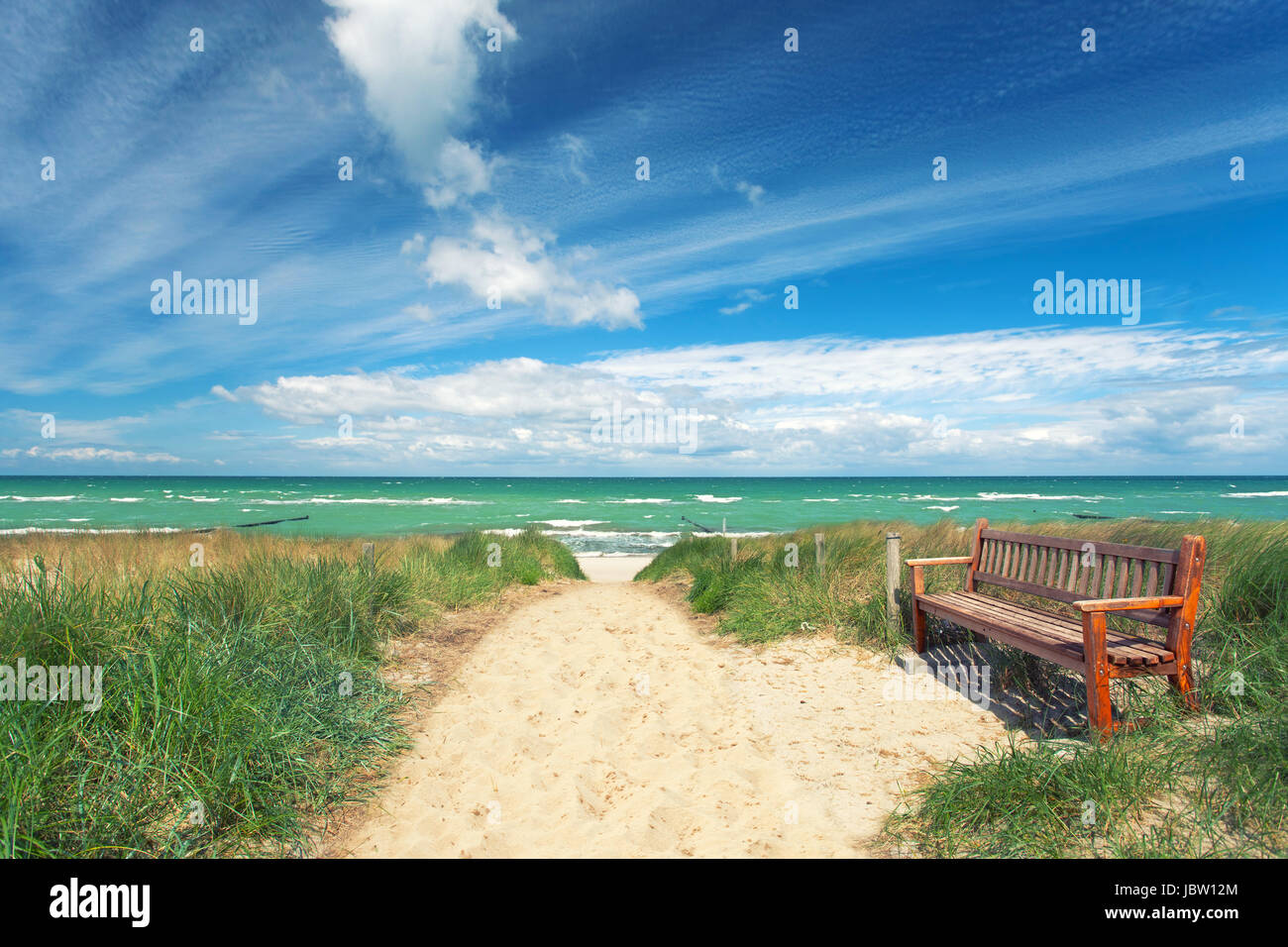 lonely bench at the beach access Stock Photo - Alamy