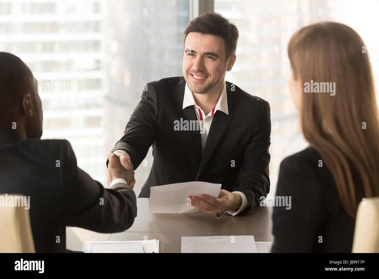 Happy applicant greeting employers at job interview, cheerful satisfied ...
