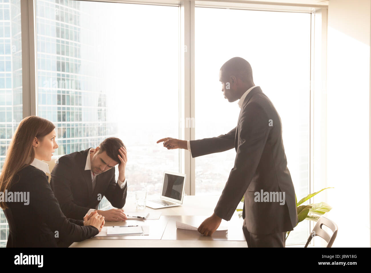 Angry bad african american boss yelling at caucasian employees ...