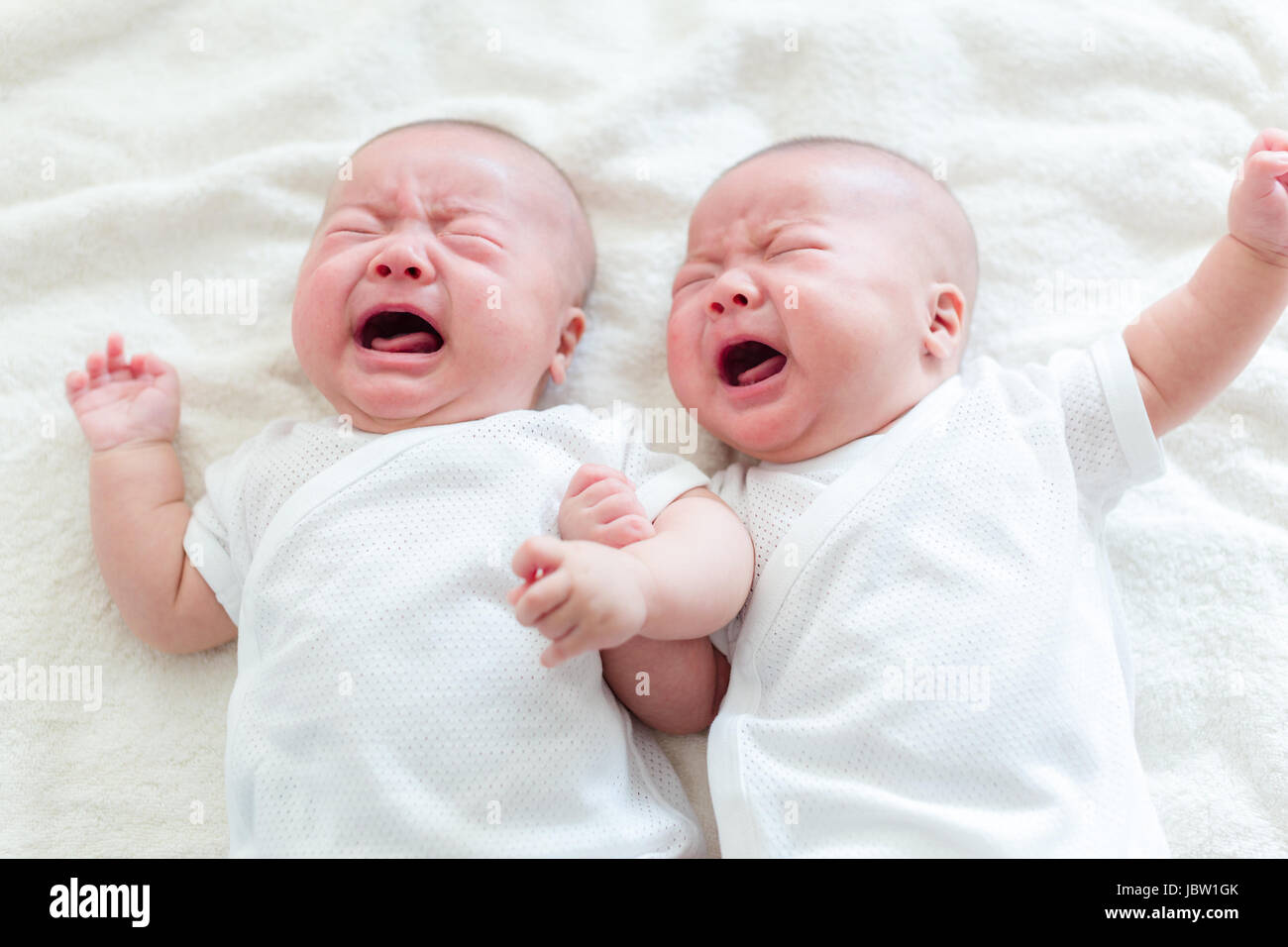 Twins brother baby crying Stock Photo - Alamy