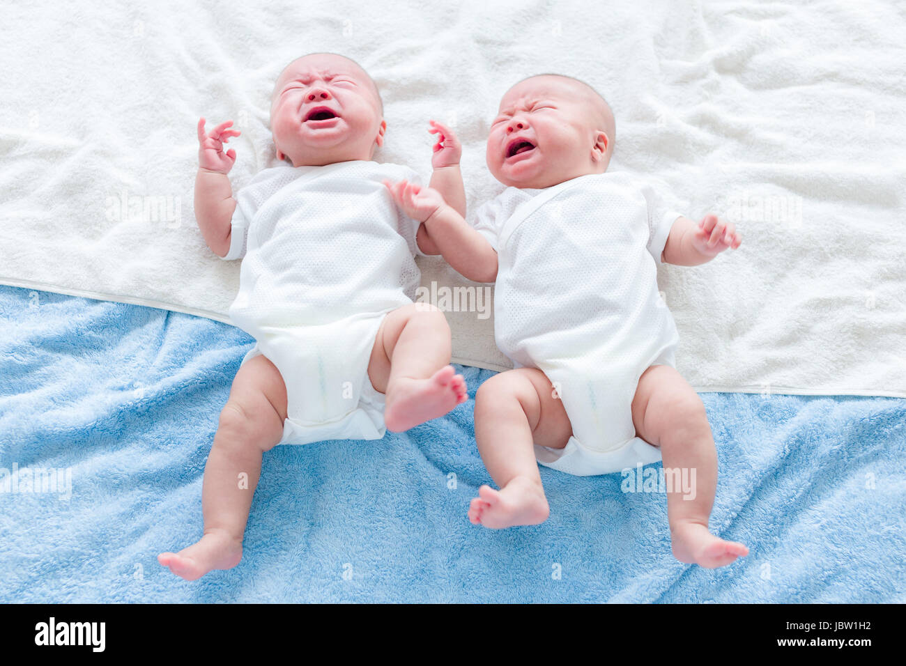 Child twins cry hi-res stock photography and images - Alamy