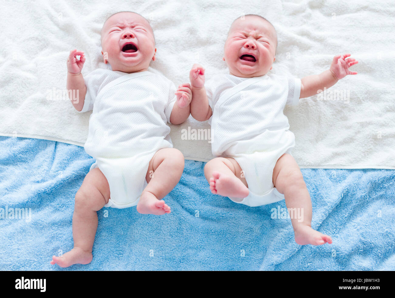 Asian new born twins crying Stock Photo - Alamy