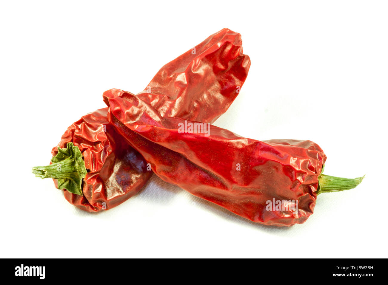 Dry red peppers isolated on white Stock Photo - Alamy