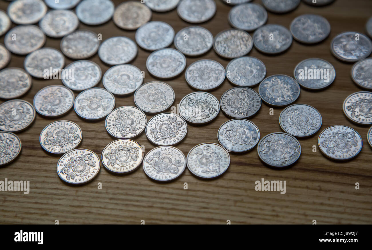 Anniversary lat coins of an old Latvian currency on a wooden background ...
