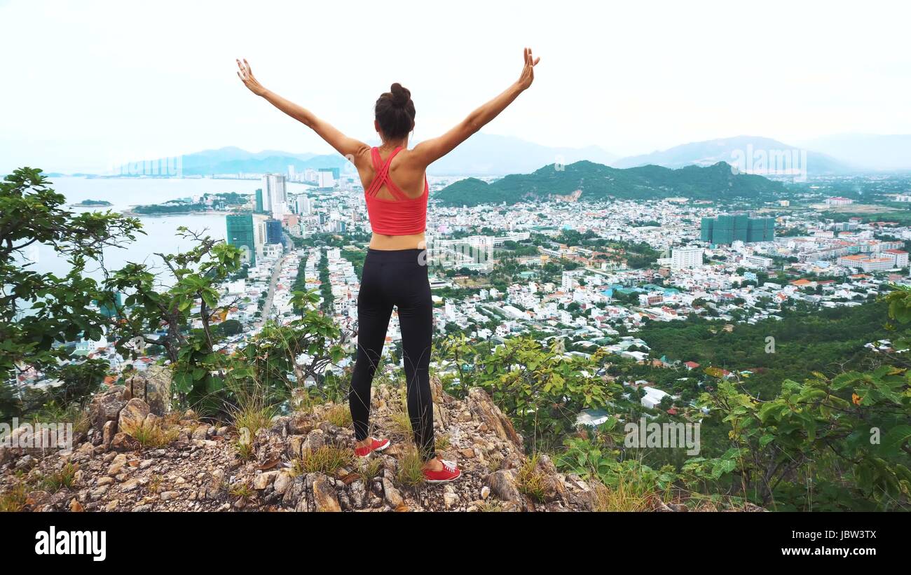 Woman runner raise hands up in the air. Female cheering in winning ...