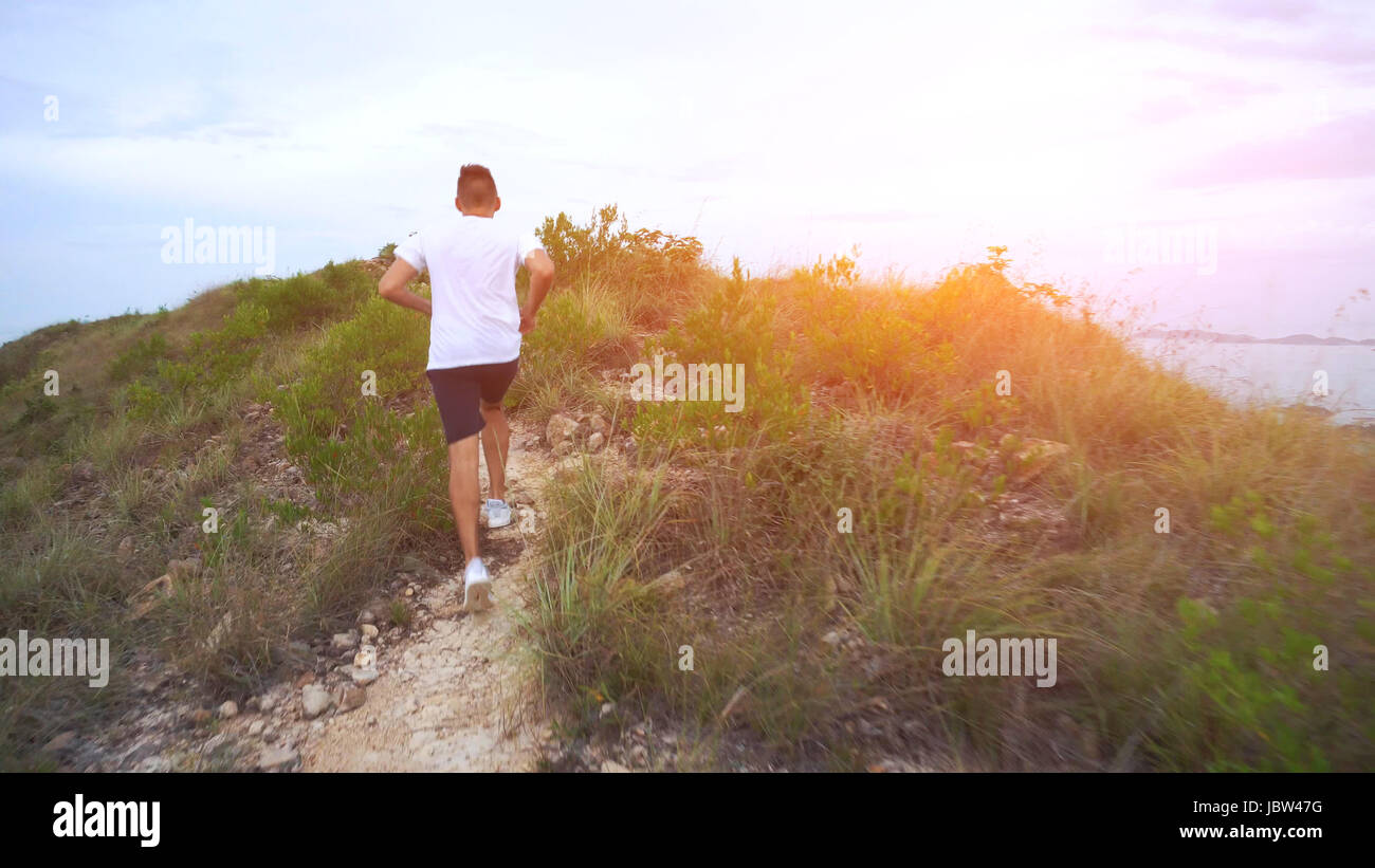 Running man on mountain road. Sport fitness boy exercising outside in ...