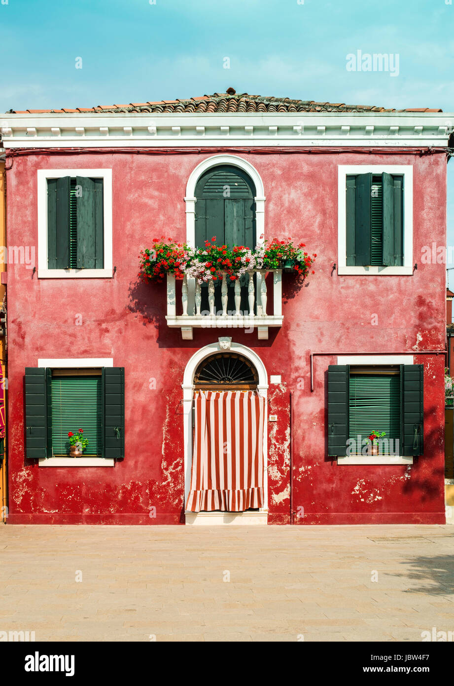 Bright red color house in Burano, Venice Stock Photo - Alamy