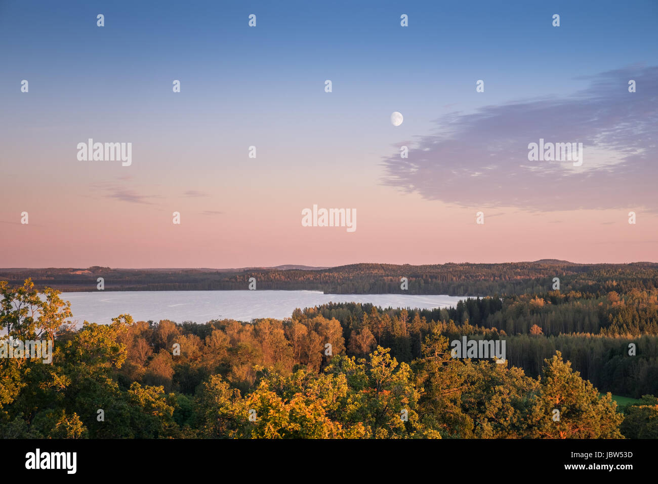 Scenic landscape with moon and sunset at autumn evening in Finland ...
