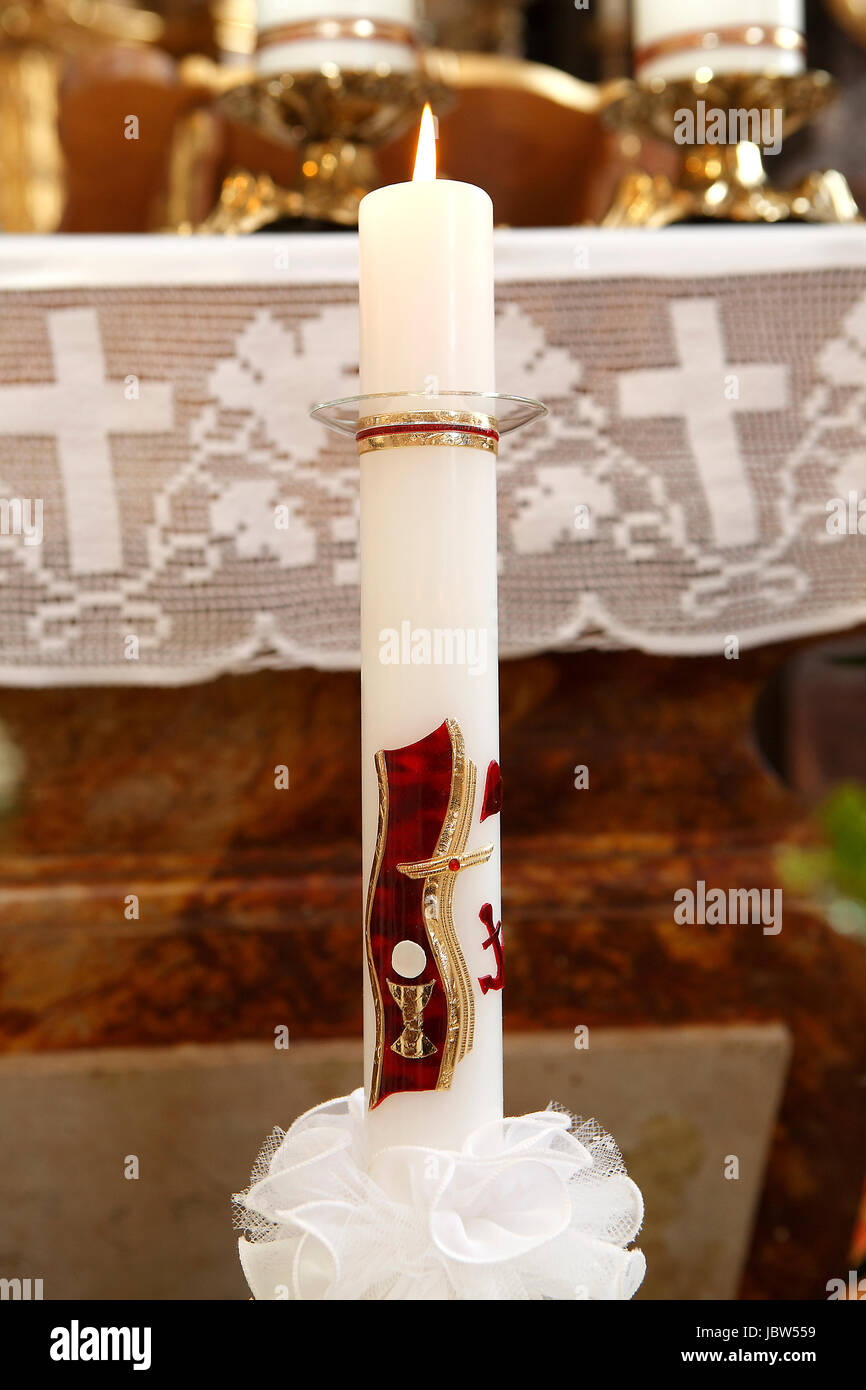 Burning candle at the communion in a catholic church Stock Photo - Alamy