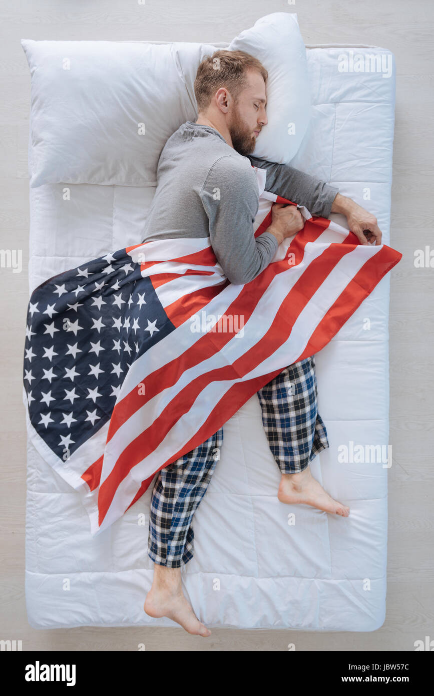 Nice patriotic man sleeping with American flag Stock Photo - Alamy