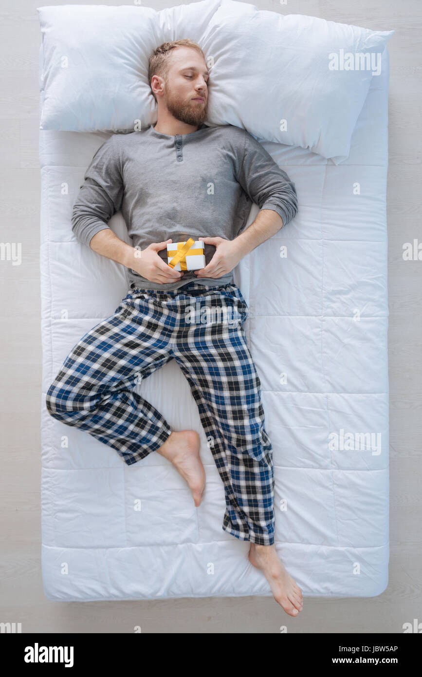 Nice brutal man holding a small gift box Stock Photo - Alamy