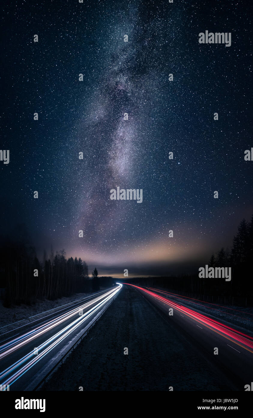 Scenic night landscape with milky way and highway Stock Photo - Alamy
